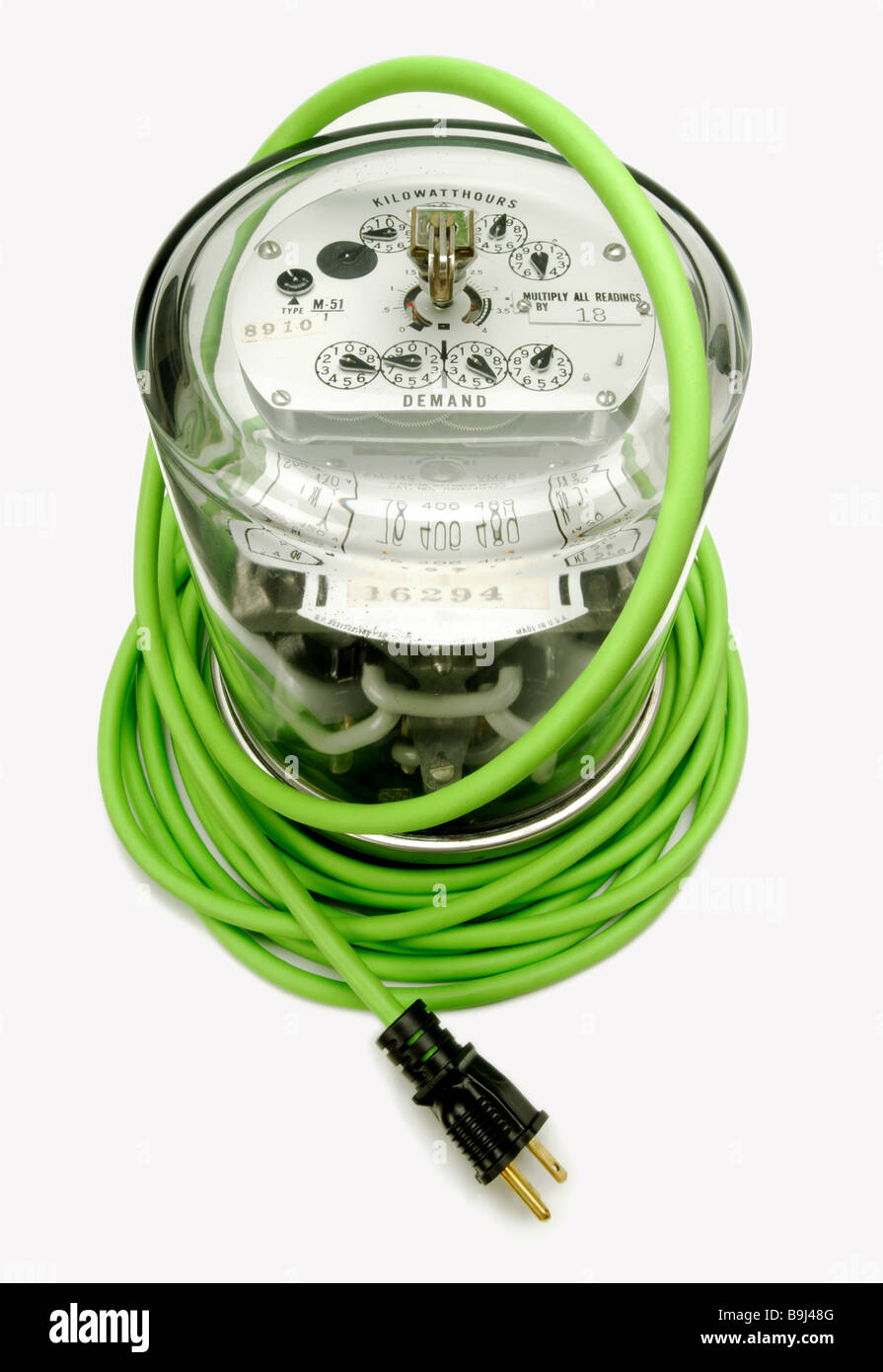 Electric power meter wrapped by a green electrical extension cord and ...