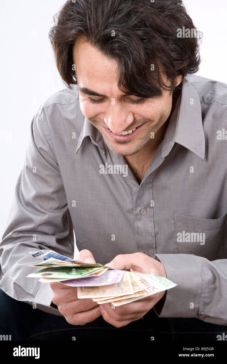 Young man counting banknotes Stock Photo - Alamy
