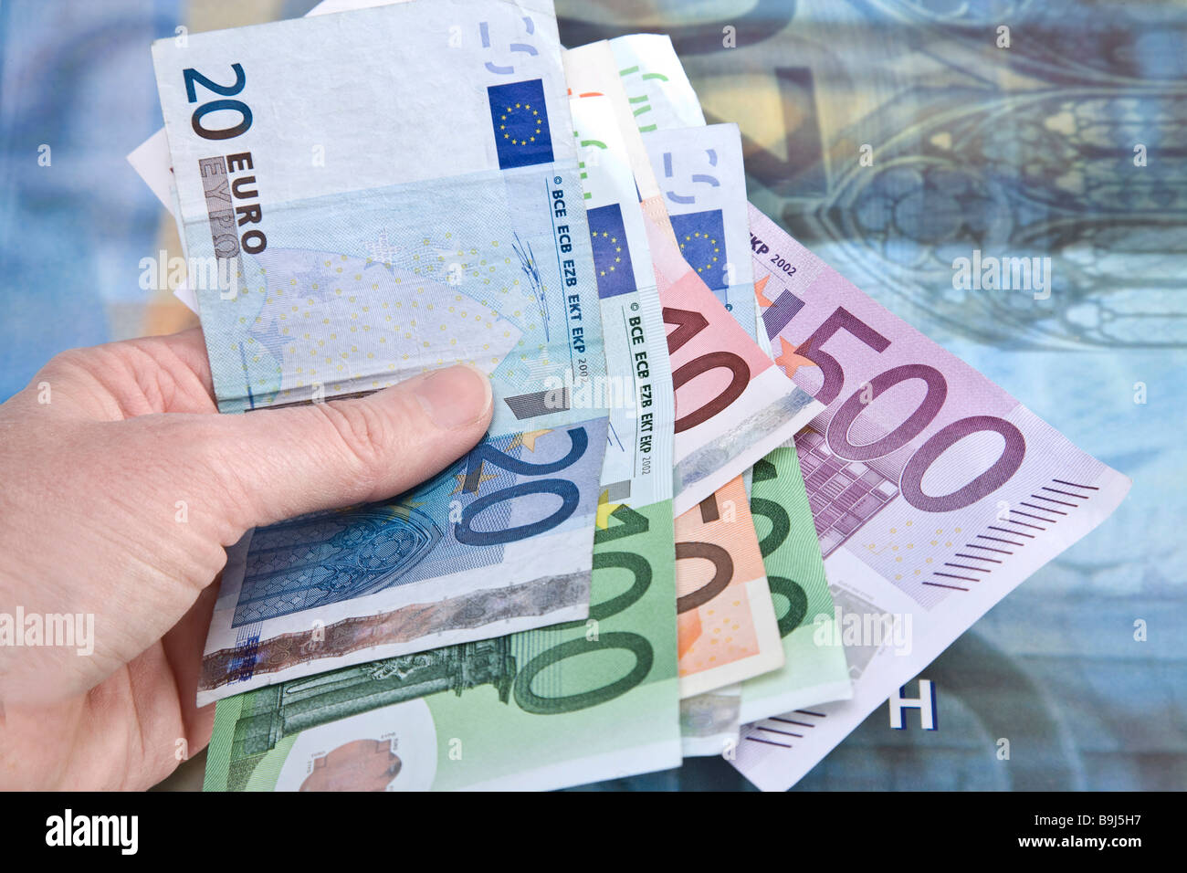Hand holding banknotes Stock Photo - Alamy