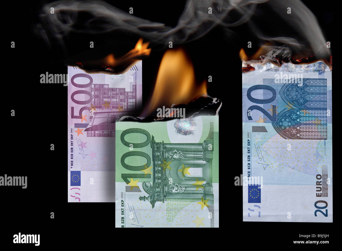 Euro banknotes on fire in front of black backdrop Stock Photo - Alamy