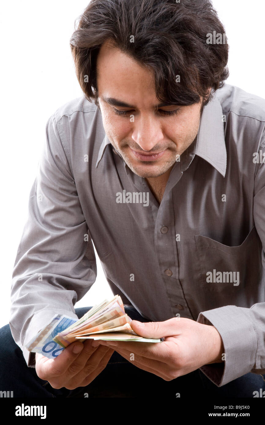 Young man counting banknotes Stock Photo - Alamy