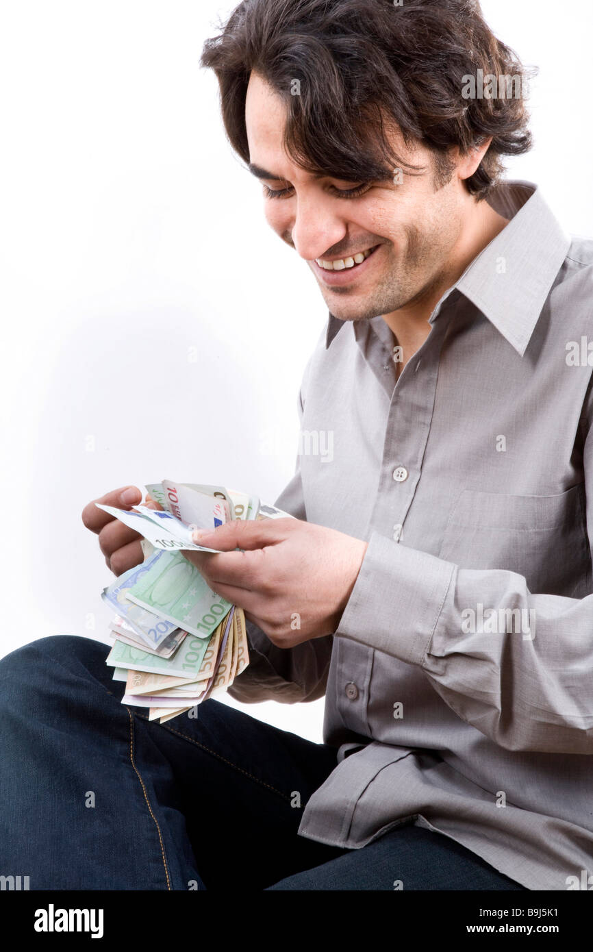 Young man counting banknotes Stock Photo - Alamy