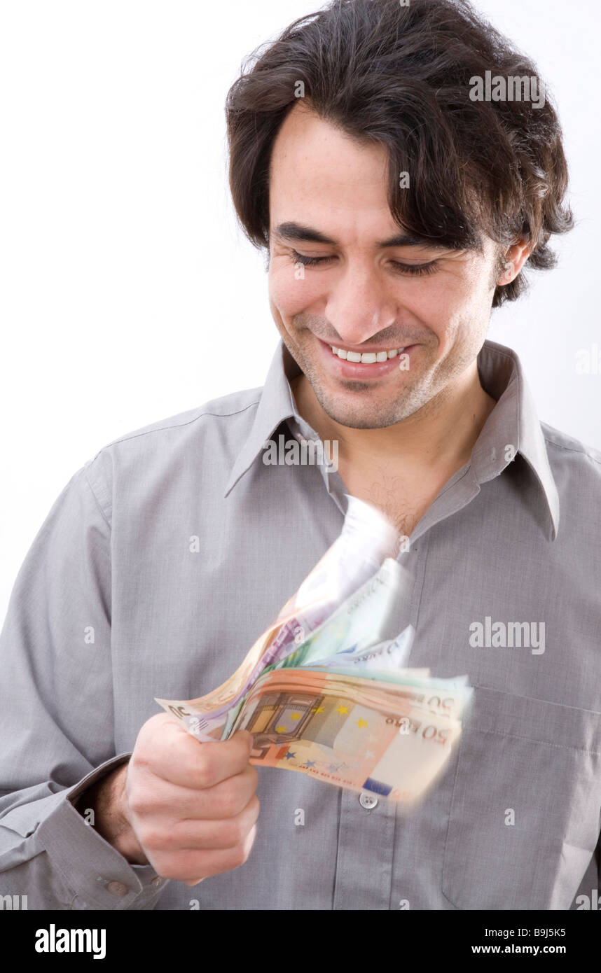 Young man fanning banknotes Stock Photo - Alamy