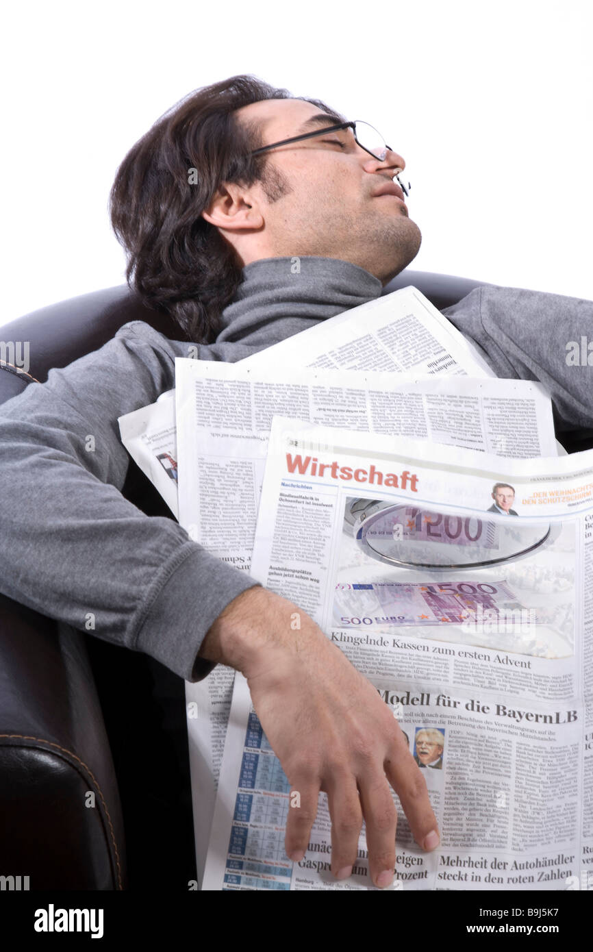 Young man sleeping on a leather armchair with a newspaper Stock Photo ...
