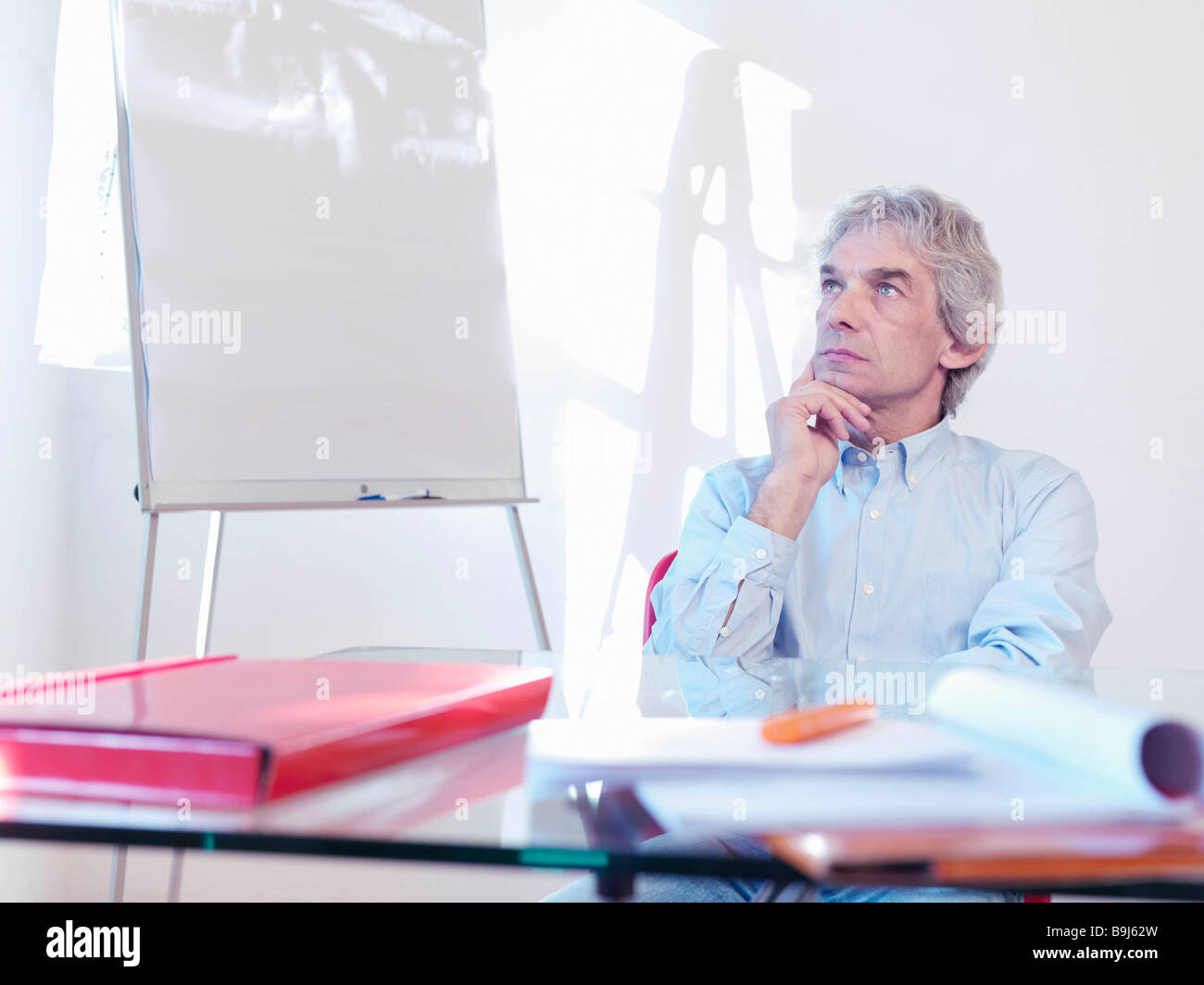 Executive sitting on desk in hi-res stock photography and images - Alamy