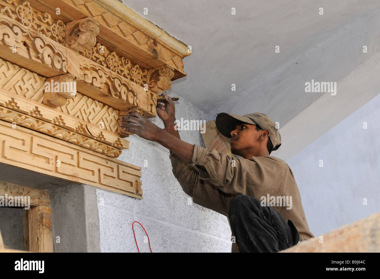Hindu worker building house of the Ladakhis, here the typical wooden ...