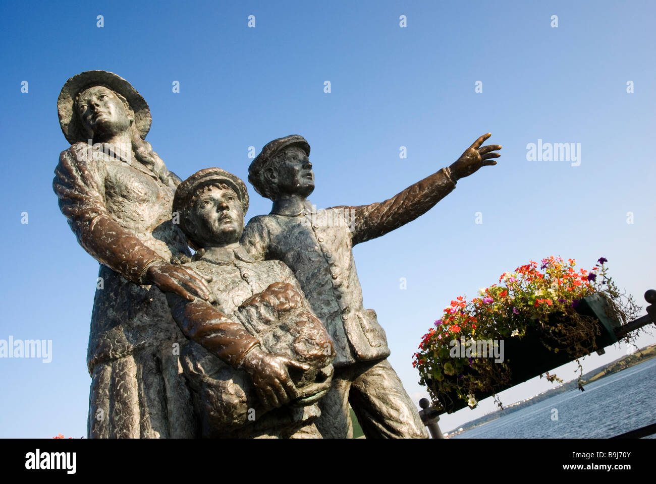 The bronze statue of Annie Moore and her two brothers outside the Cobh ...