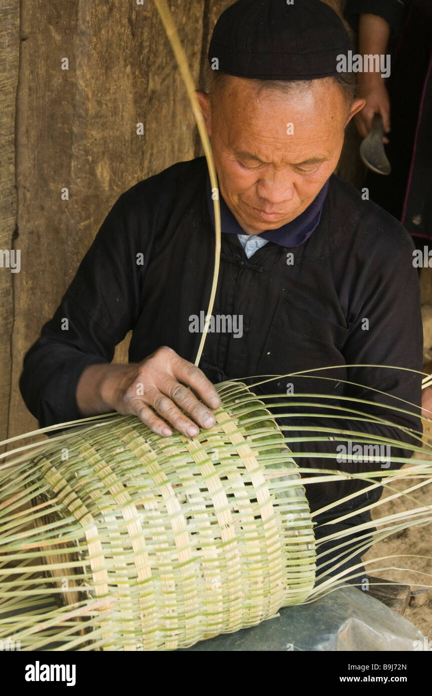 Black Hmong man weaving a basket in his home near Sapa Vietnam Stock ...