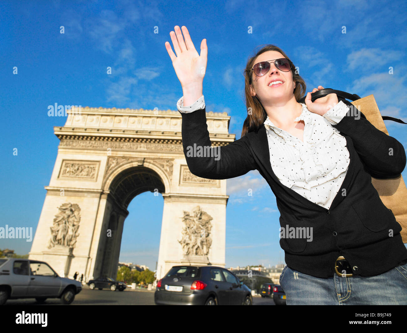 Woman hailing cab Stock Photo - Alamy
