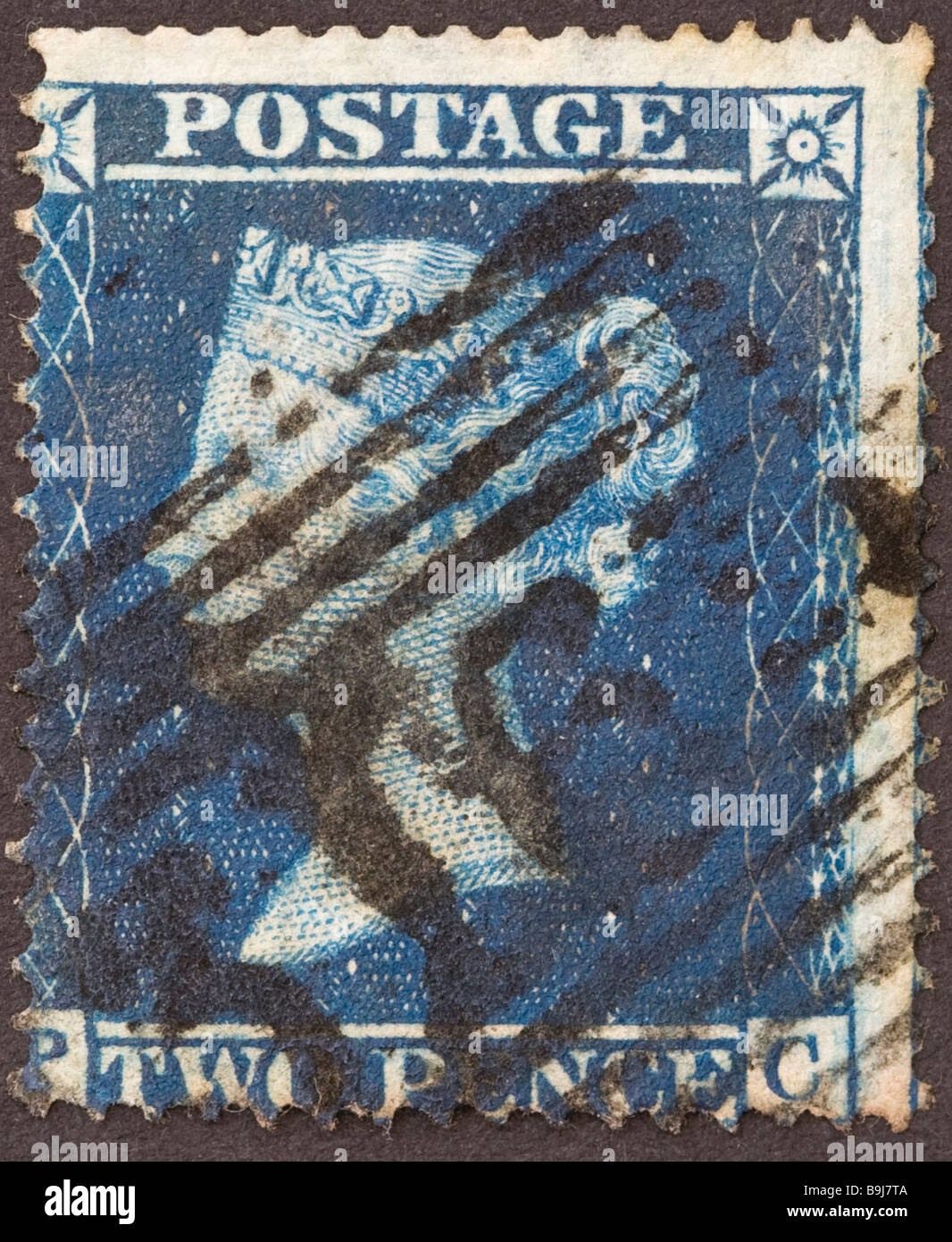 Close up of 2d blue Victorian British Postal stamp on black background ...