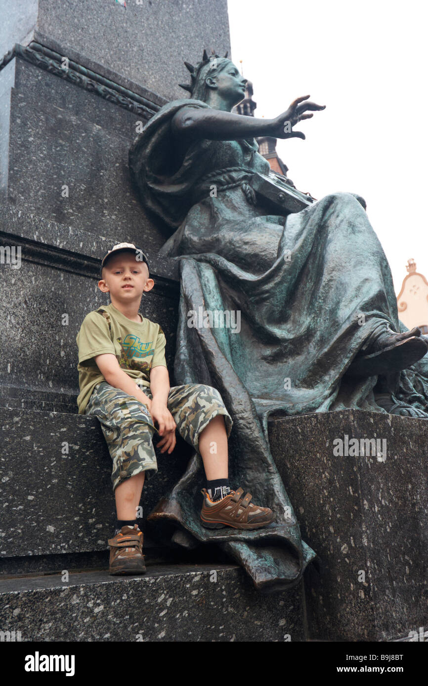 child sitting on a monument Stock Photo - Alamy