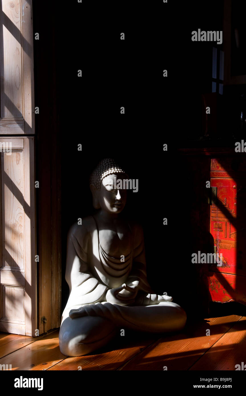 Daylight shining in through window on a staue of Buddah Stock Photo - Alamy