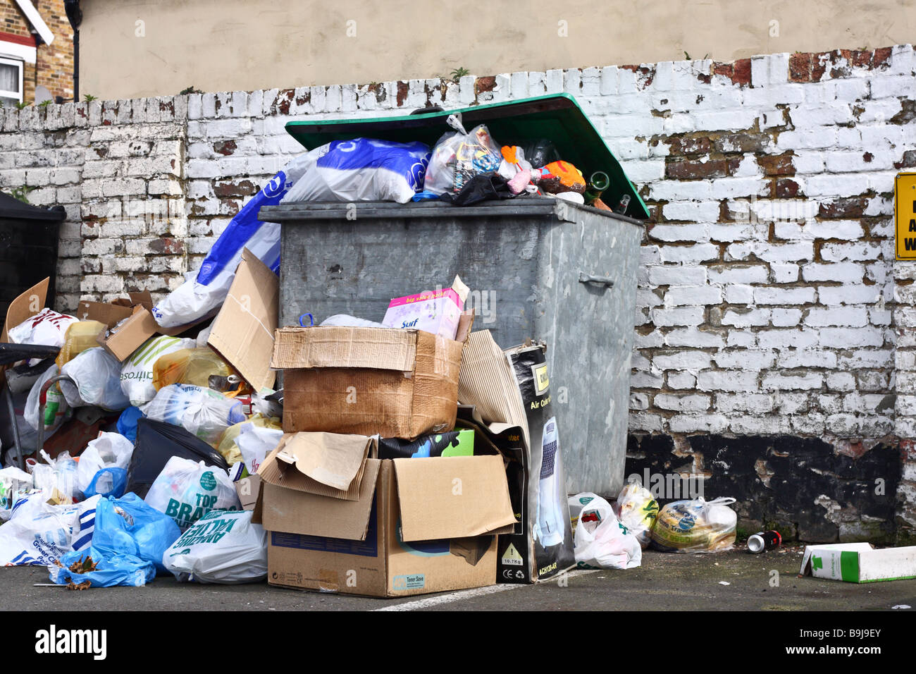 Trash overflowing from a garbage bin in Hounslow London Stock Photo - Alamy