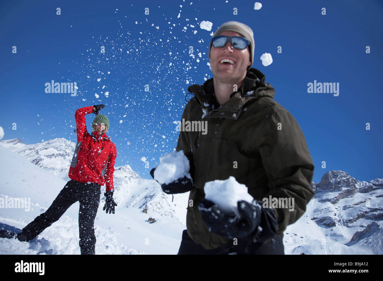 Young couple playing in snow Stock Photo - Alamy