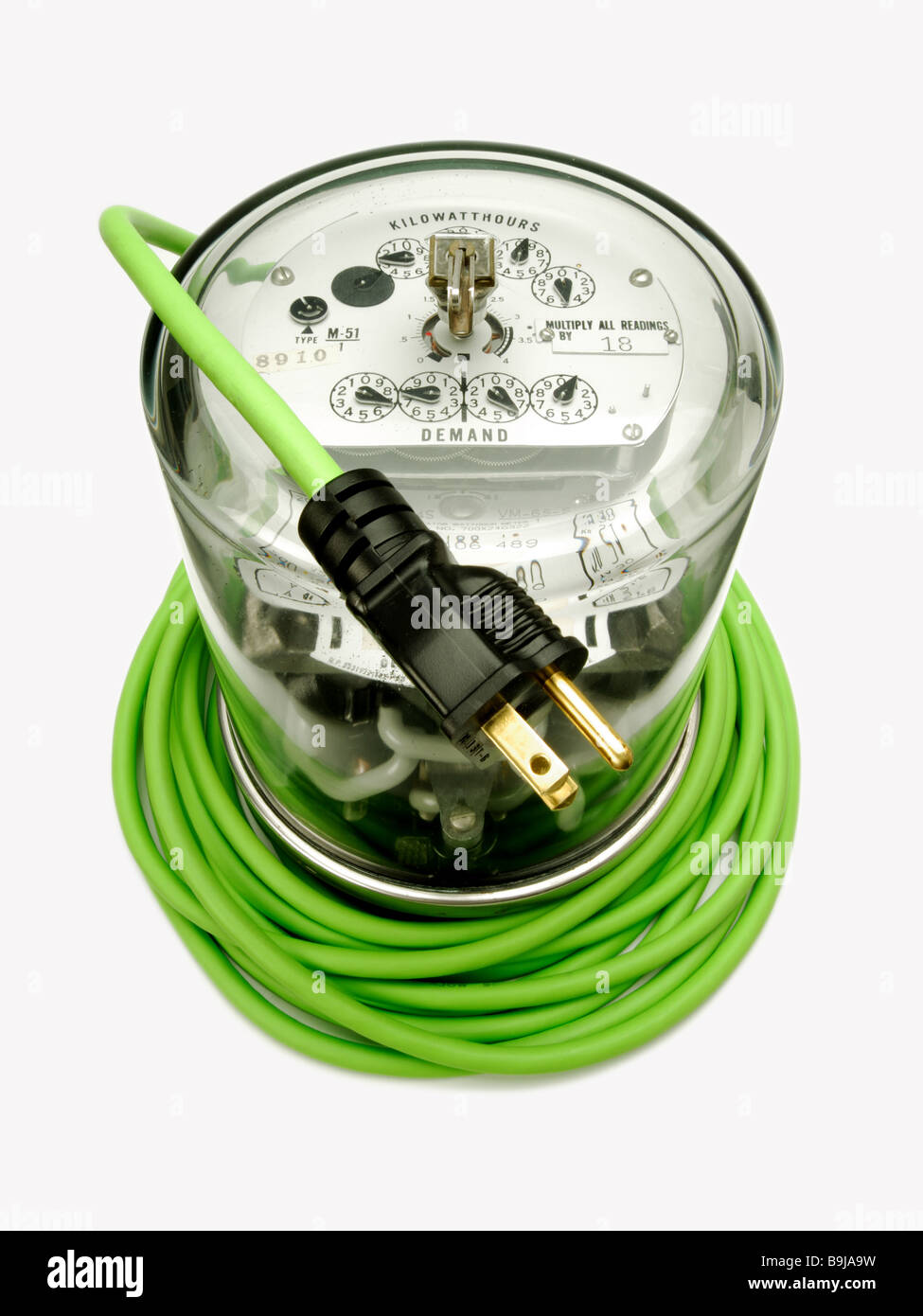 Electric power meter wrapped by a green electrical extension cord and ...