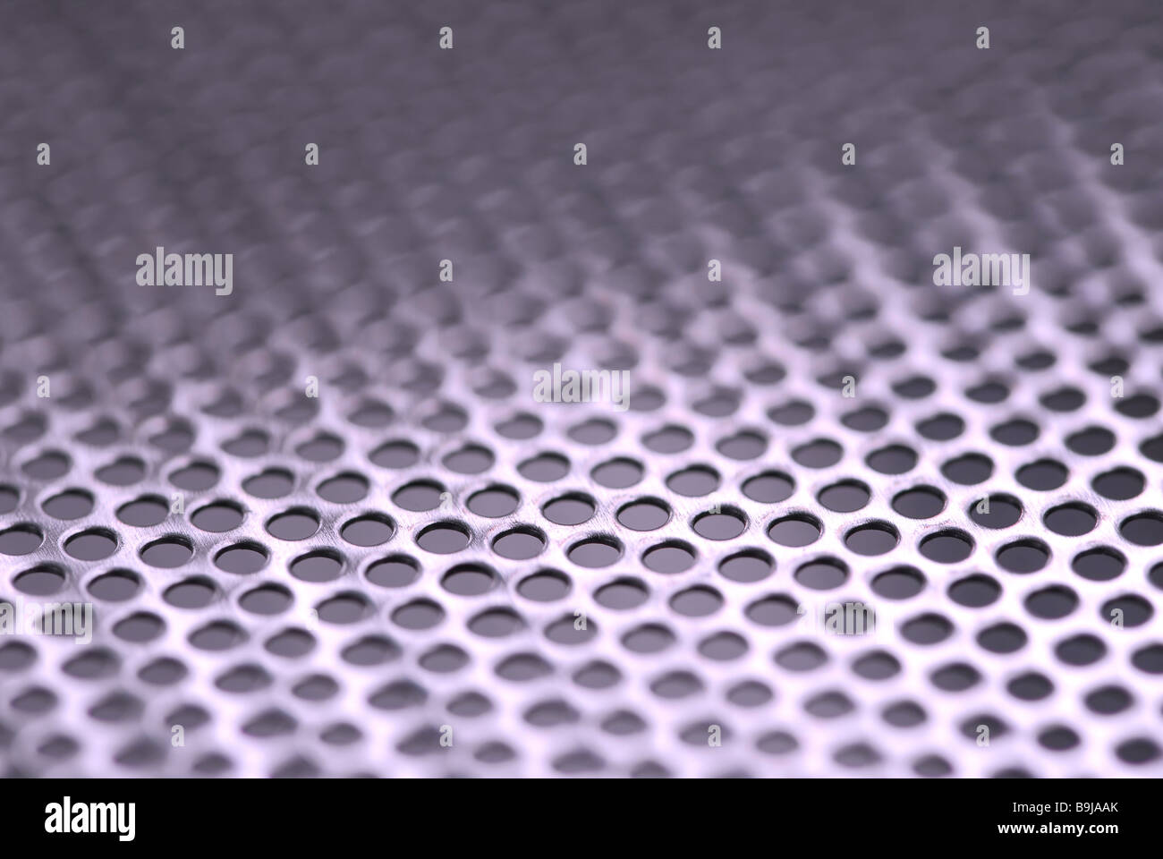 Abstract background of perforated metal with very shallow dof Stock ...