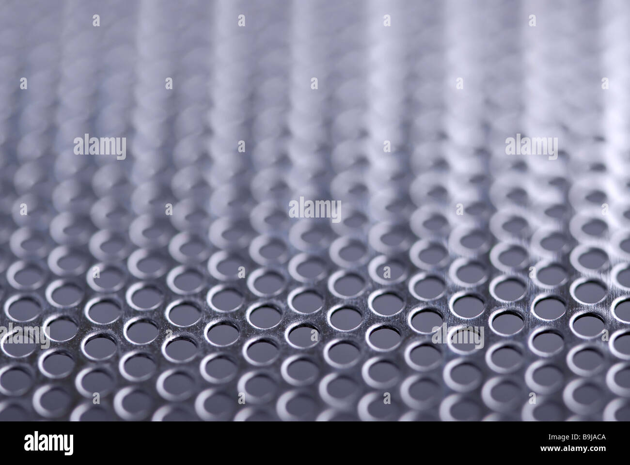 Abstract background of perforated metal with very shallow dof Stock ...
