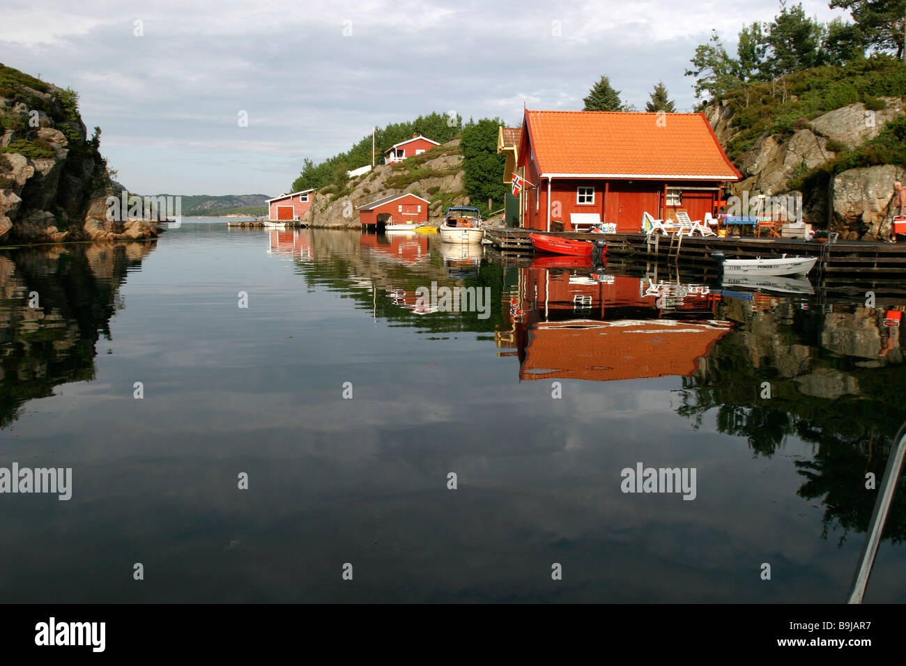 Traditionally built red houses in a fjord near Avik, Norway ...