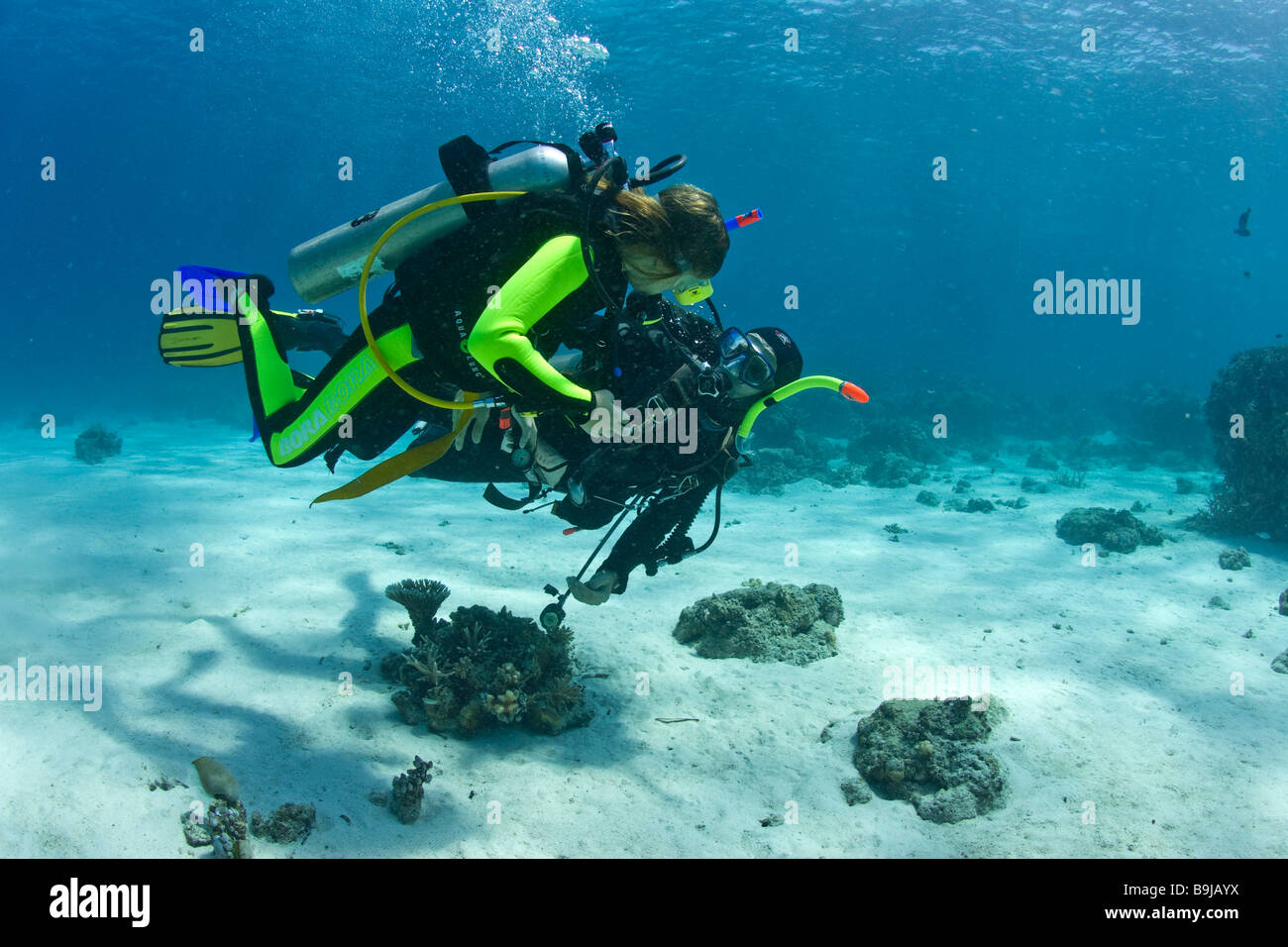 Scuba diving teacher with a child doing the diver's quaification in the ...