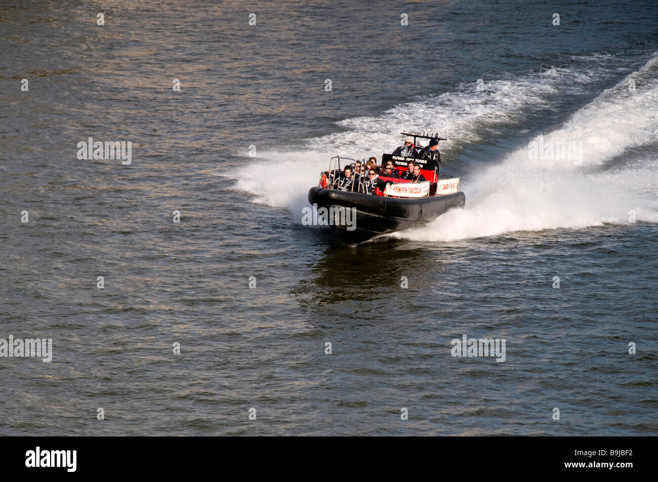 Tourists on a "Flying Fish Tours" speedboat ride on river Thames in ...