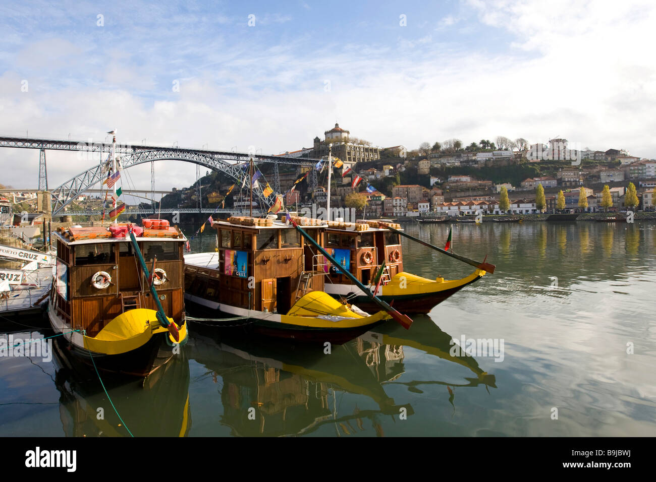 Tourist boats at the quay of the Rio Douro river, Don Luis I Bridge at ...