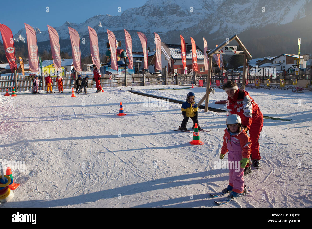 Children being taught by a ski instructor in a beginners course in a ...