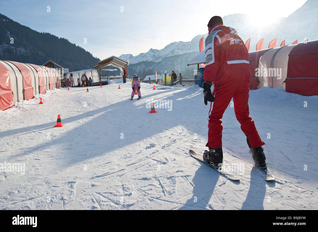 Children being taught by a ski instructor in a beginners course in a ...