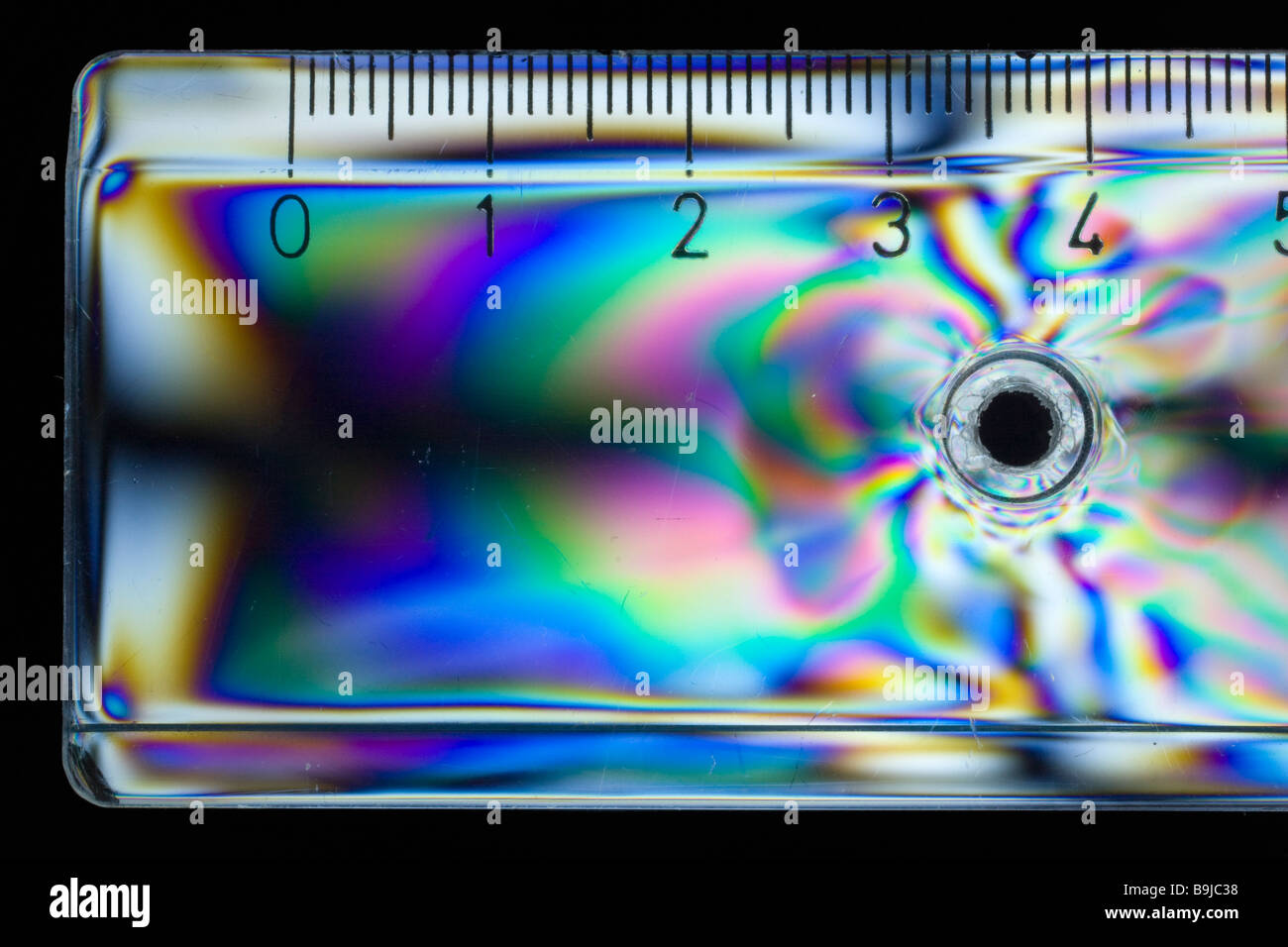 Stress patterns in a plastic rule Stock Photo - Alamy