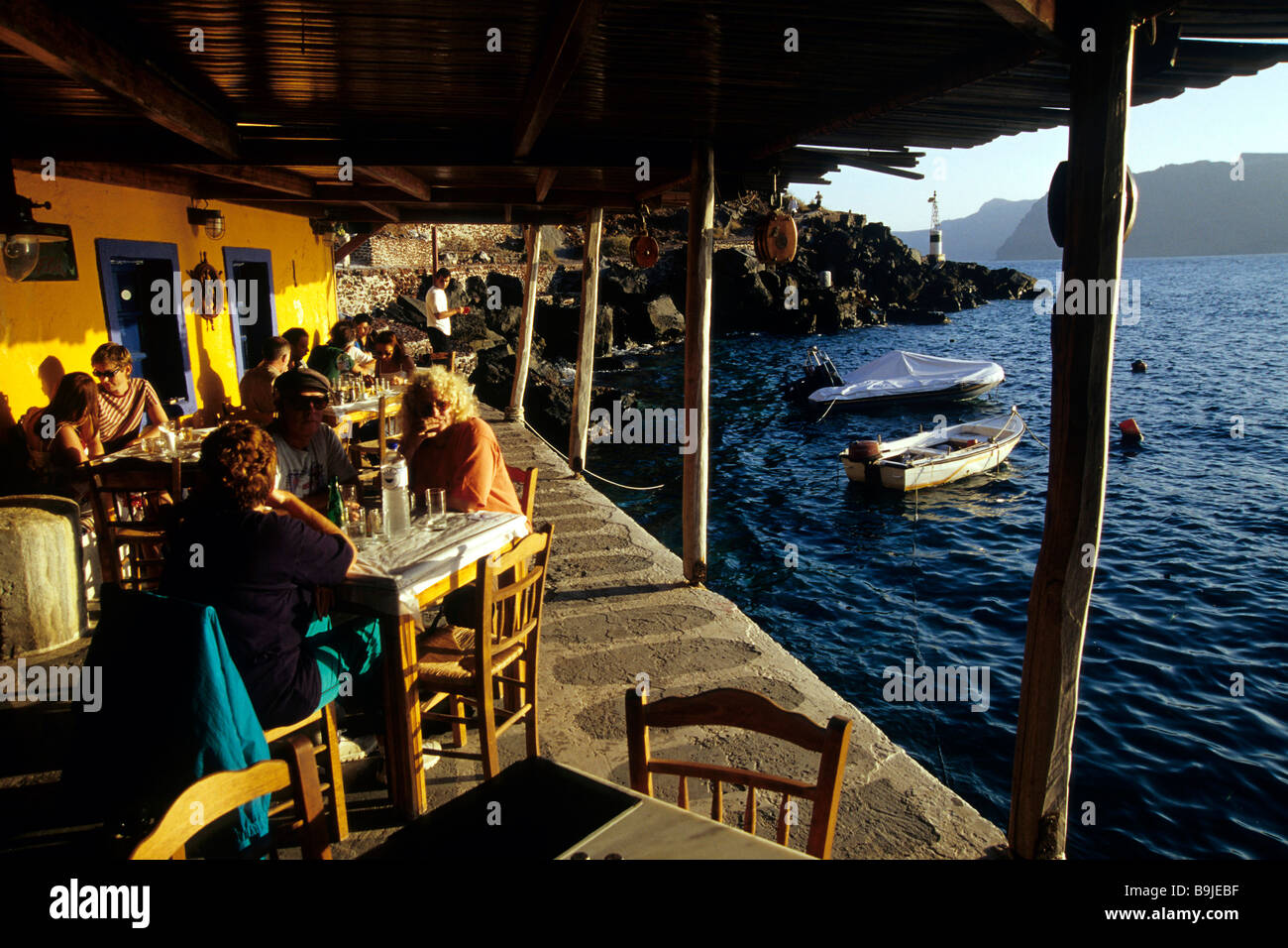 The second harbour of Oia at the crater rib of the volcano with a bar ...