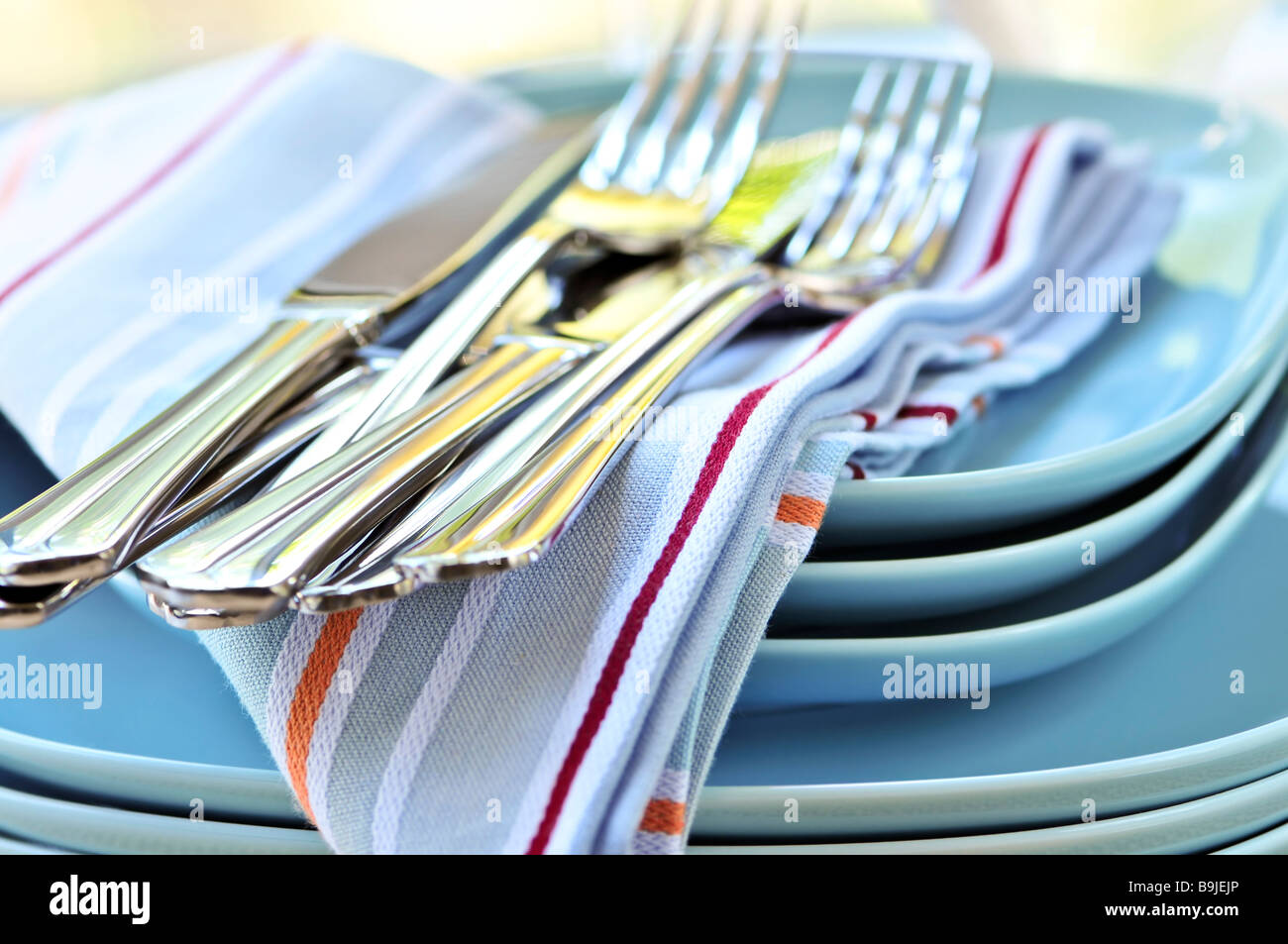 Table setting with stack of plates and cutlery Stock Photo - Alamy