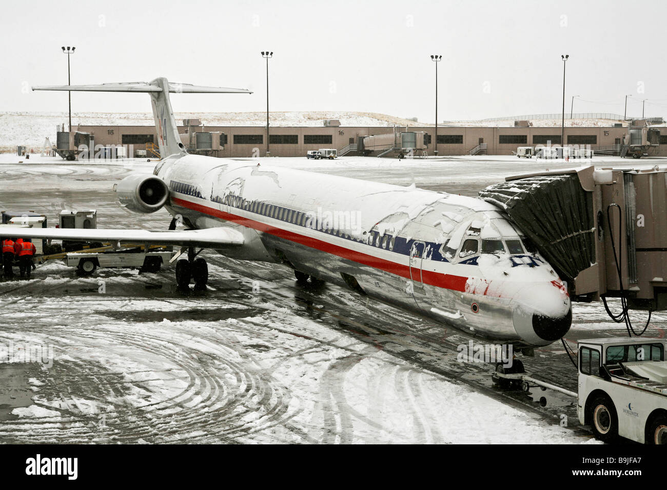 Snow covered Jet airliner being prepped for flight in the snow Stock ...