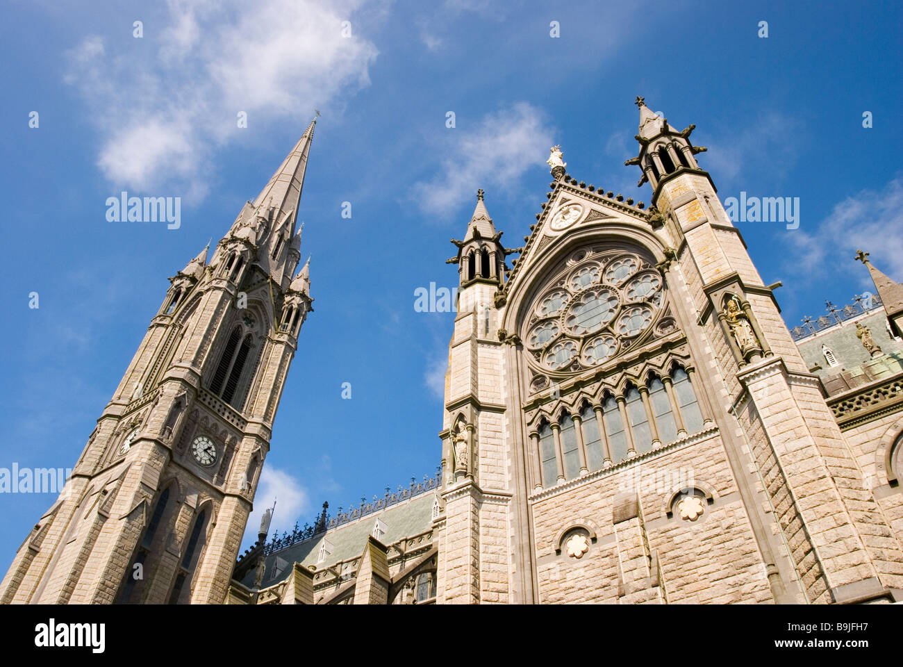 The tower of St. Colman's Cathedral towers above the coastal town of ...