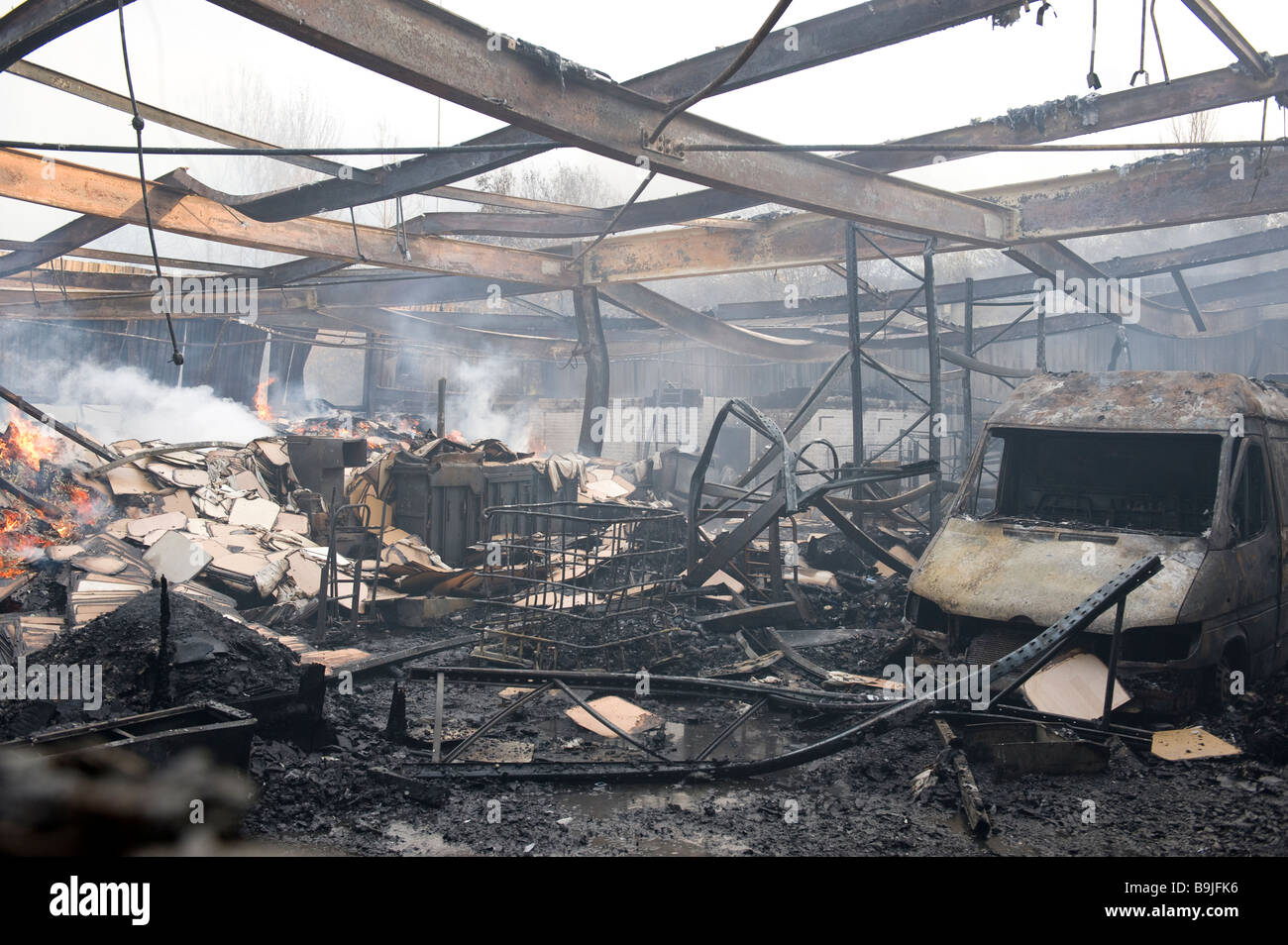 A burnt out smoldering factory with vehicle inside warehouse Stock ...