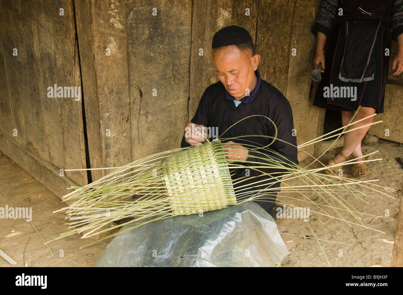 Black Hmong man weaving a basket in his home near Sapa Vietnam Stock ...