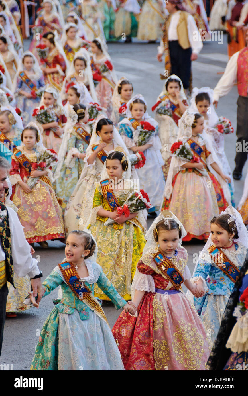 Young children Falleras parade towards Plaza de la Virgen with flower ...