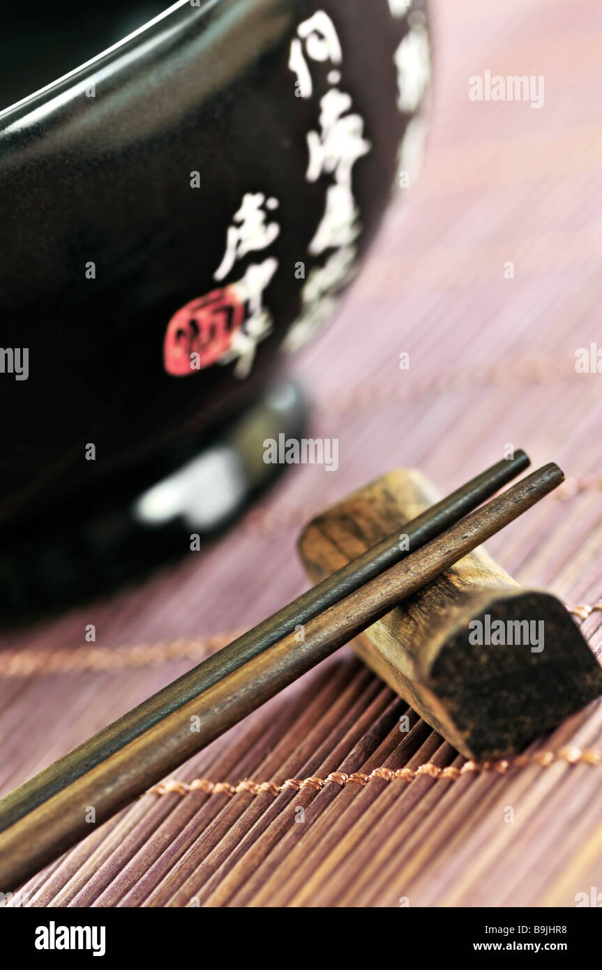 Asian rice bowl and wooden chopsticks on a rest close up Stock Photo ...