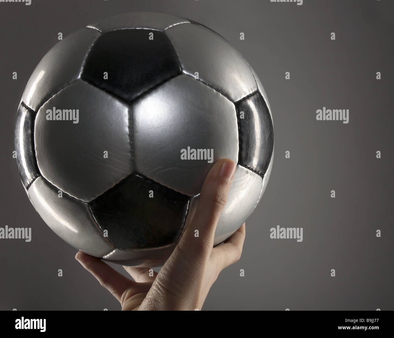 Hand holding football ball silver gray black women-hand woman symbol ...
