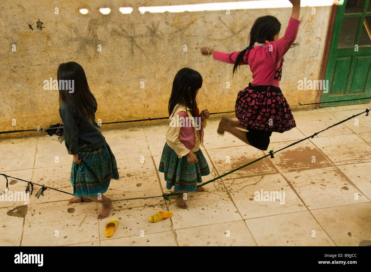 Black Hmong girls jumping rope in Sapa Vietnam Stock Photo - Alamy