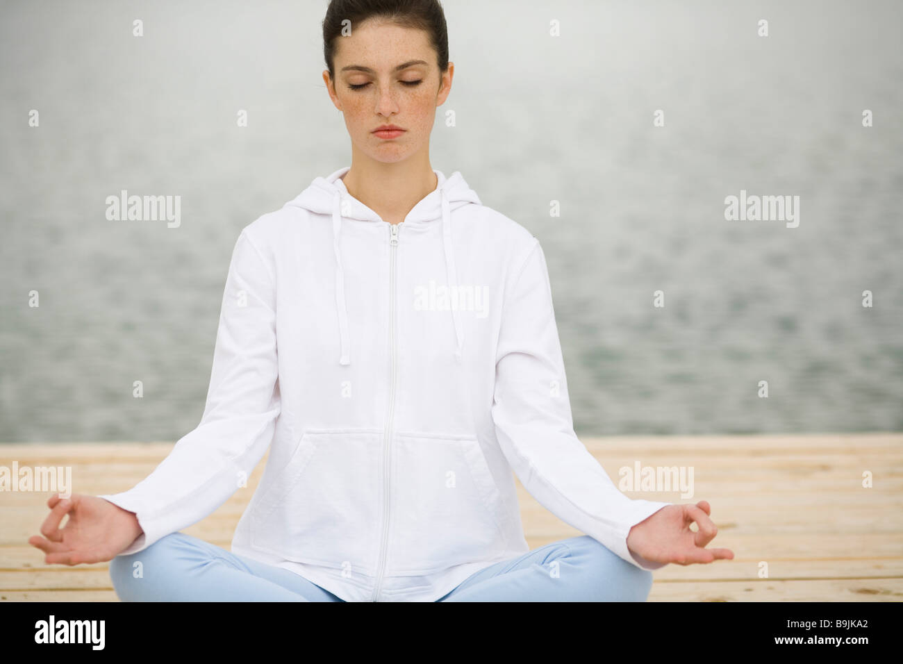 Young woman in lotus posture Stock Photo - Alamy