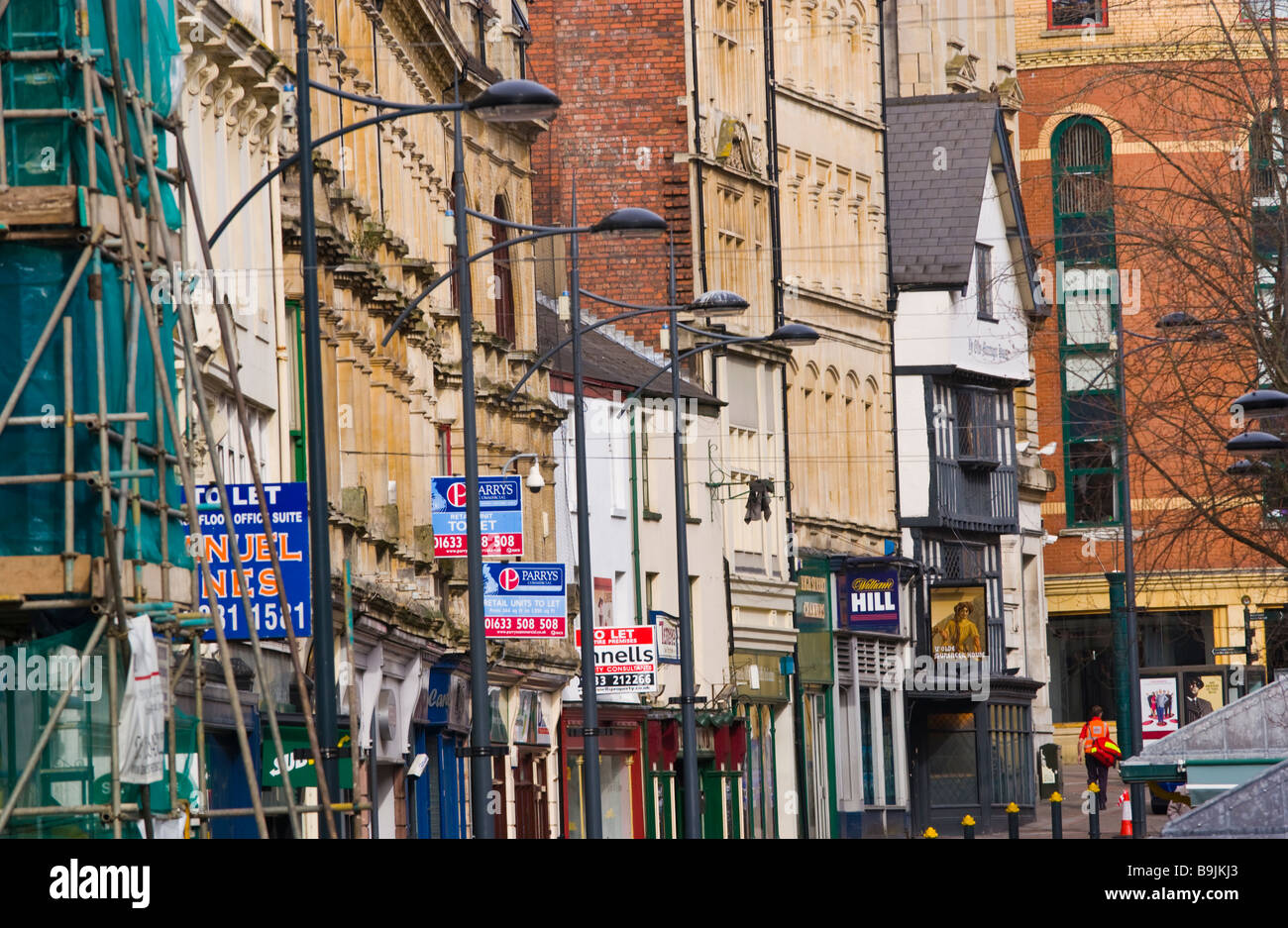 View of shopping street with Victorian facade above modern shop fronts ...