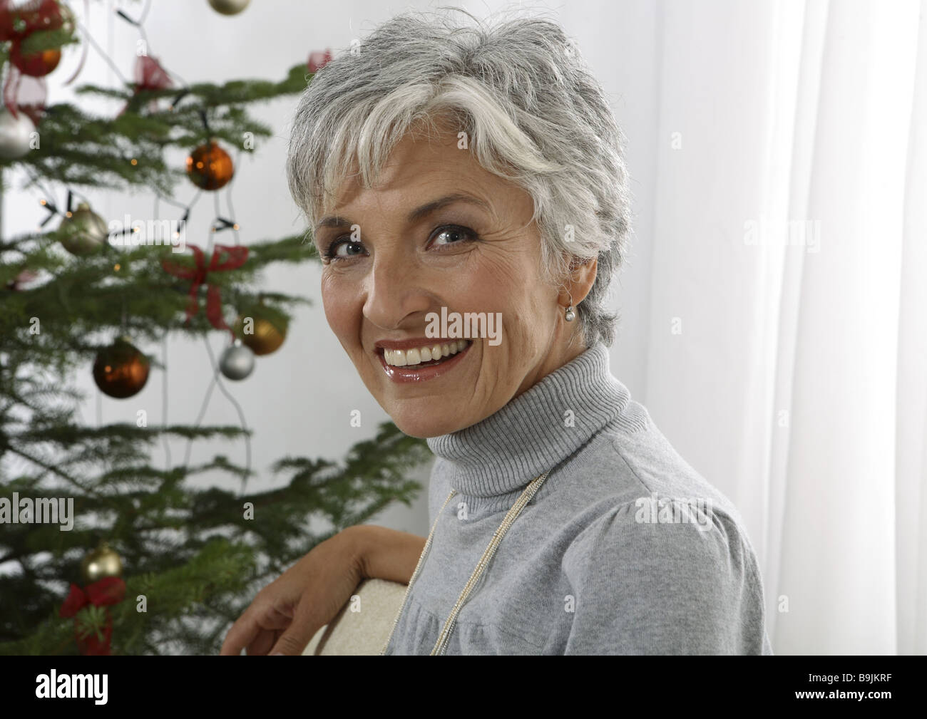 Smile senior christmas-tree portrait Stock Photo - Alamy