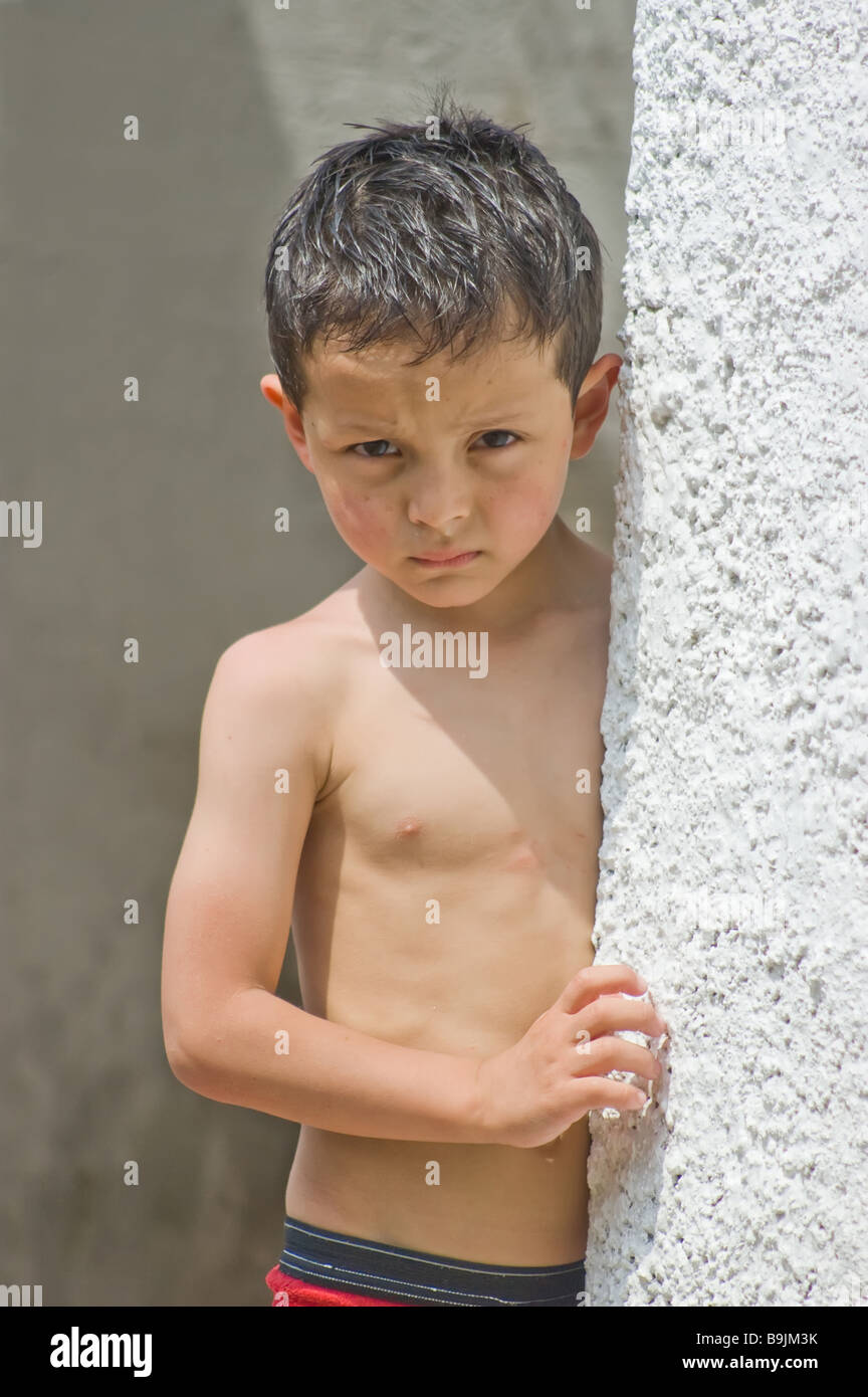 A scared little boy afraid of going swimming Stock Photo - Alamy