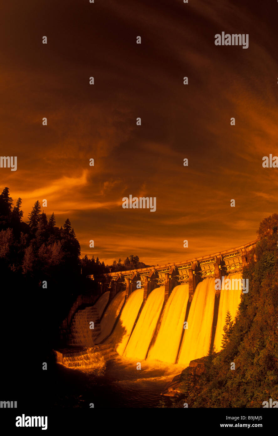 Dramatic shot of water flowing over floodgates of BC Hydro Ruskin Dam ...