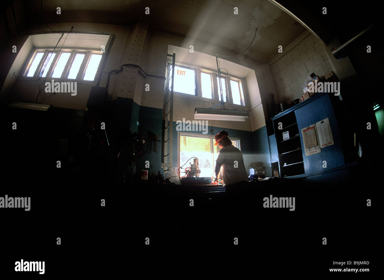 Man in workshop working at bench Stock Photo - Alamy