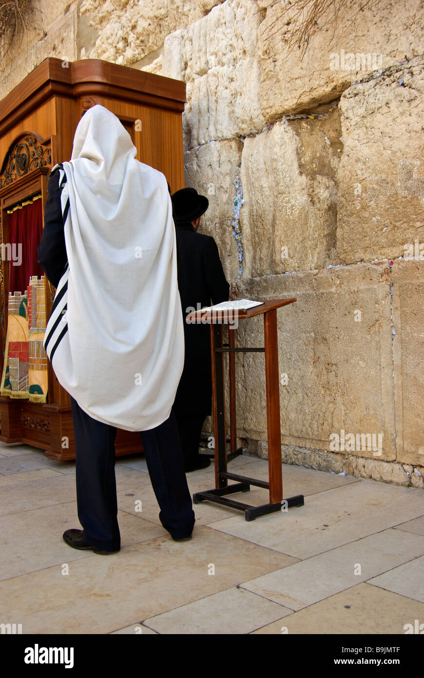Devout Jewish men praying at exposed section of ancient Holy Western ...