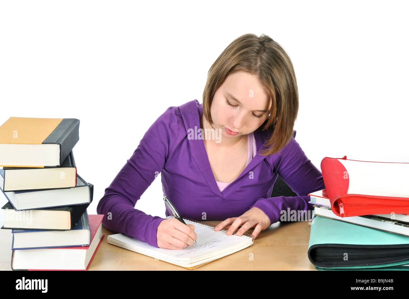 Happy teenage girl studying at the desk Stock Photo - Alamy