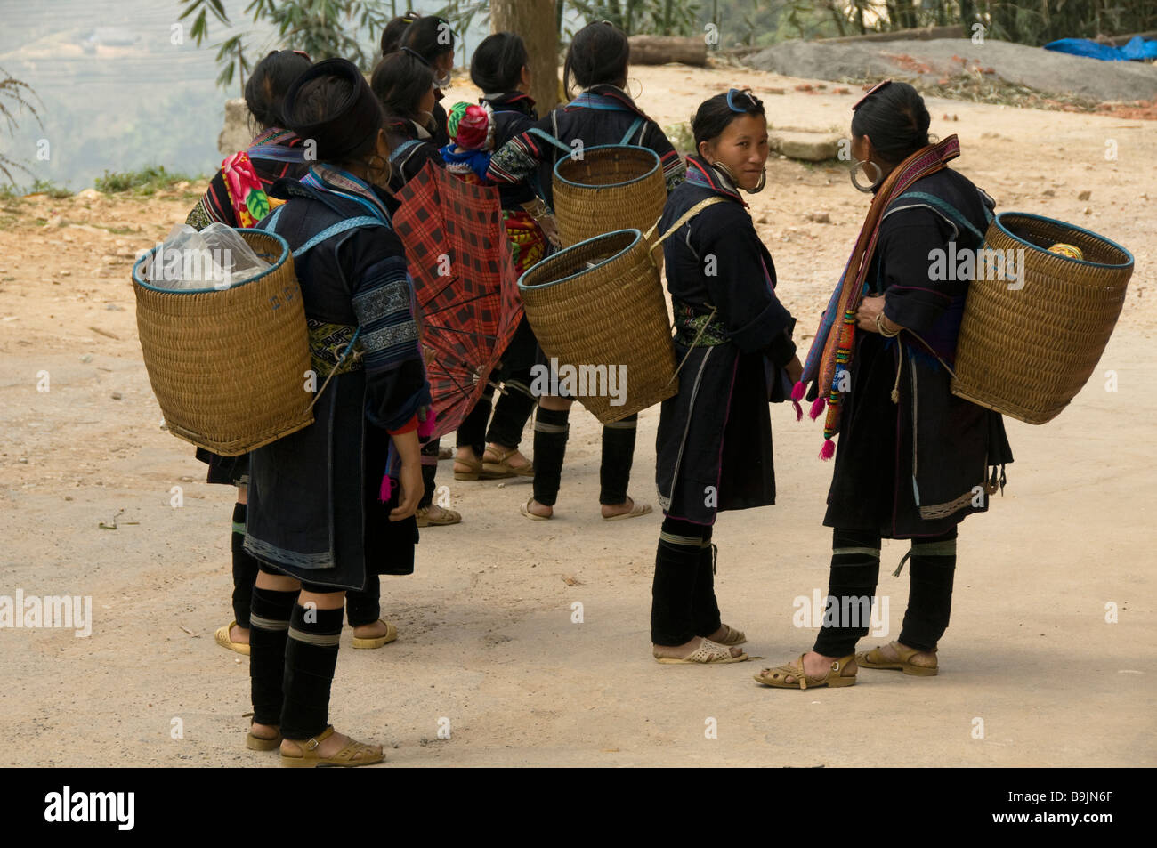 Black Hmong women and their baskets walking near Sapa Vietnam Stock ...