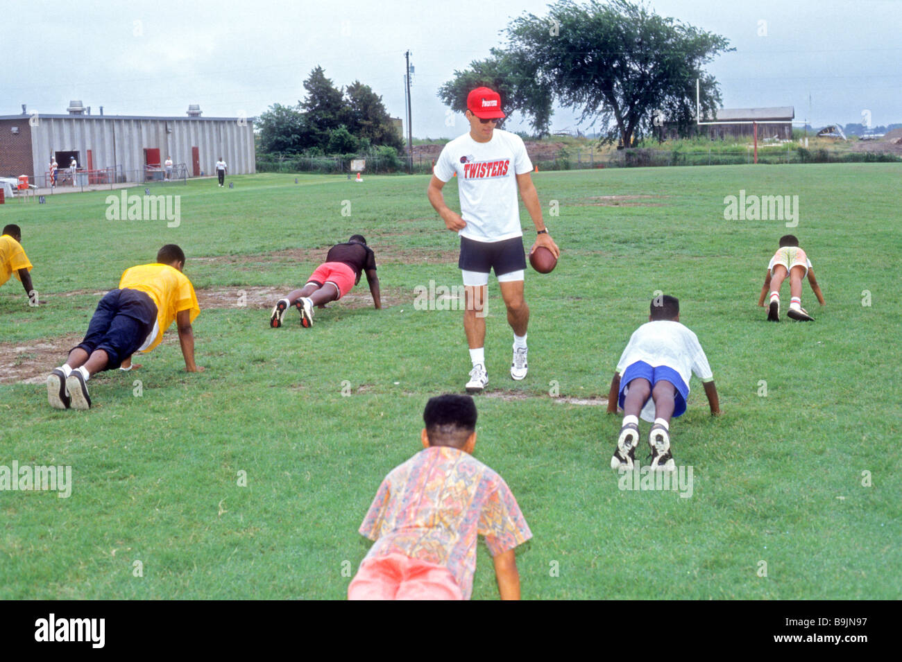 football coach exercise push-up work out physical grass field train ...