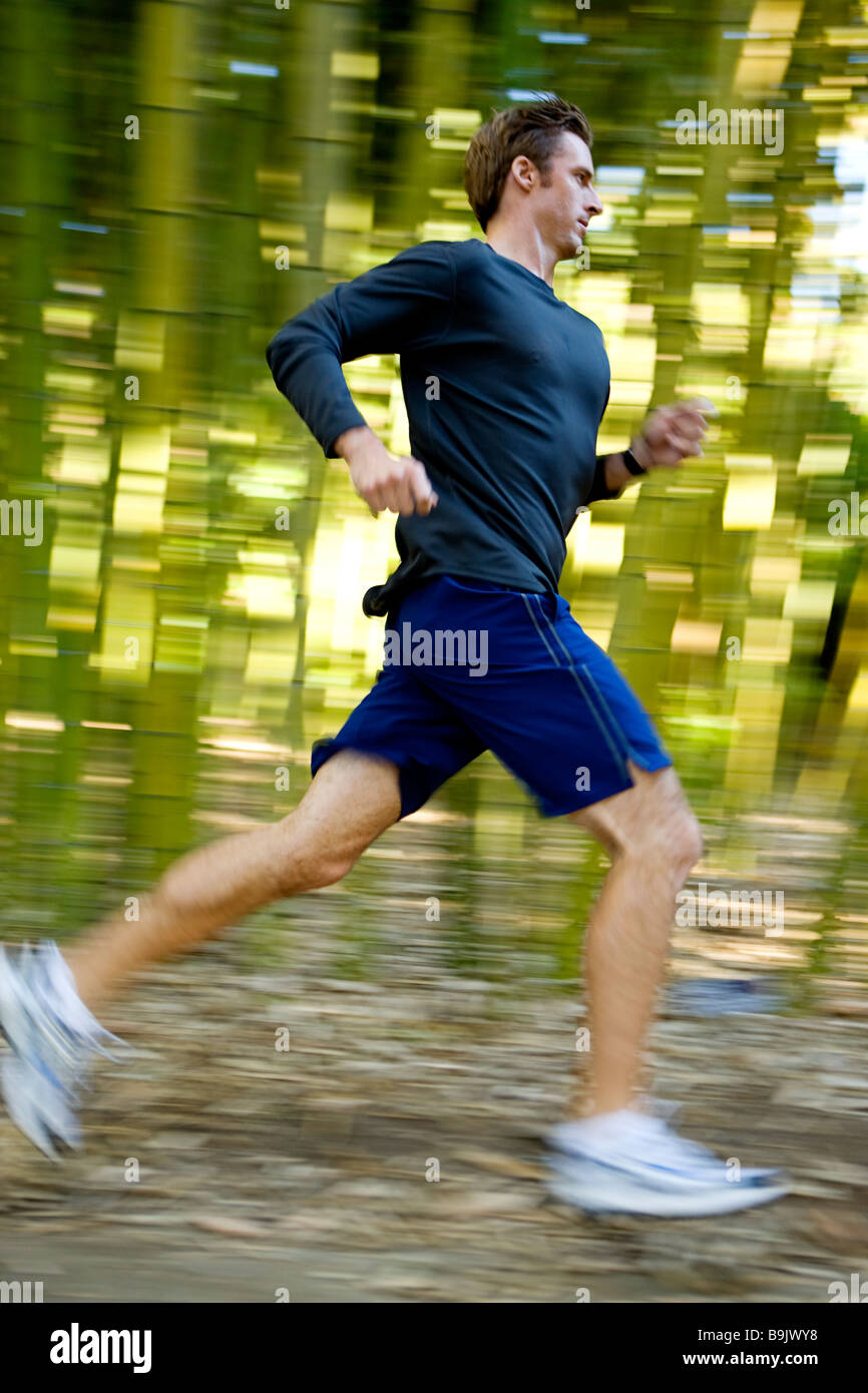 Man trail running in the woods Stock Photo - Alamy