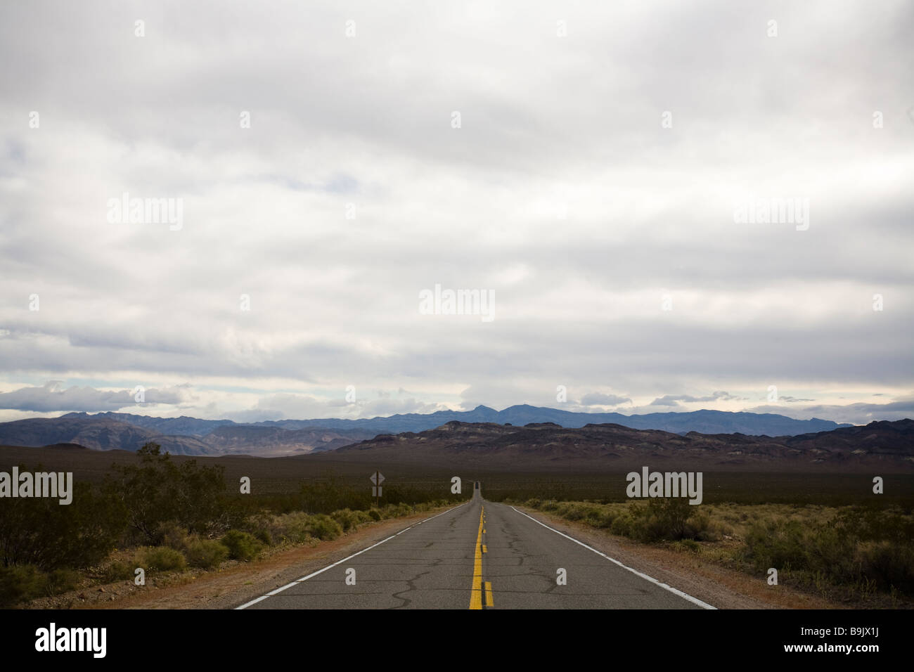 A road continues straight into the distance in Death Valley National ...